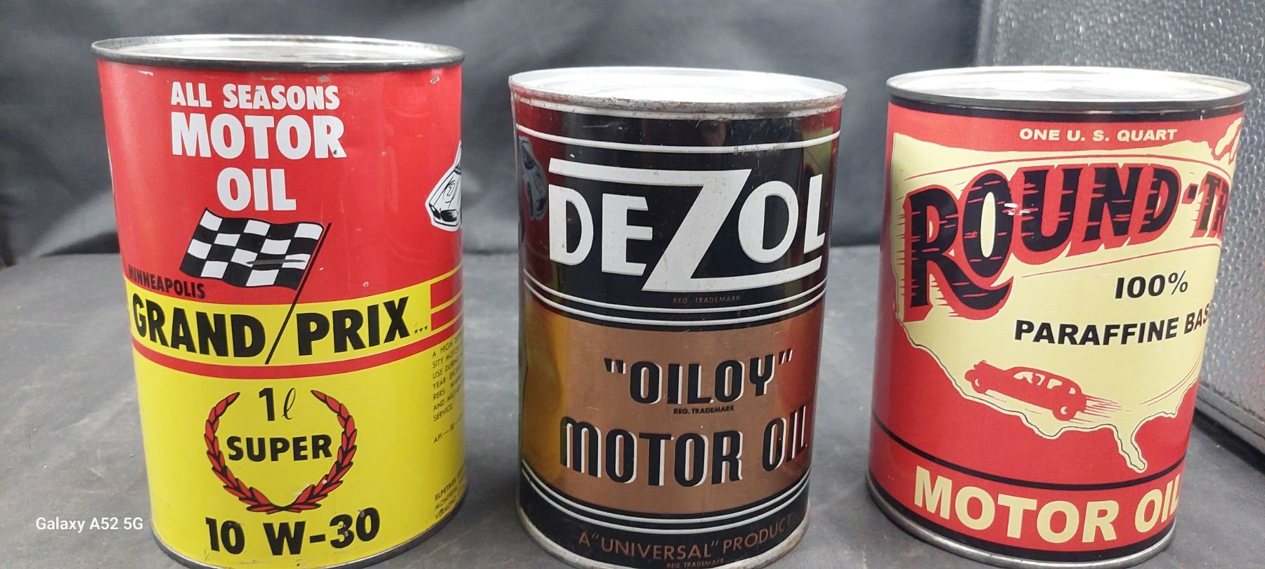 3 vintage Dezol, grand prix and roundtrip U.S. Oil quarts