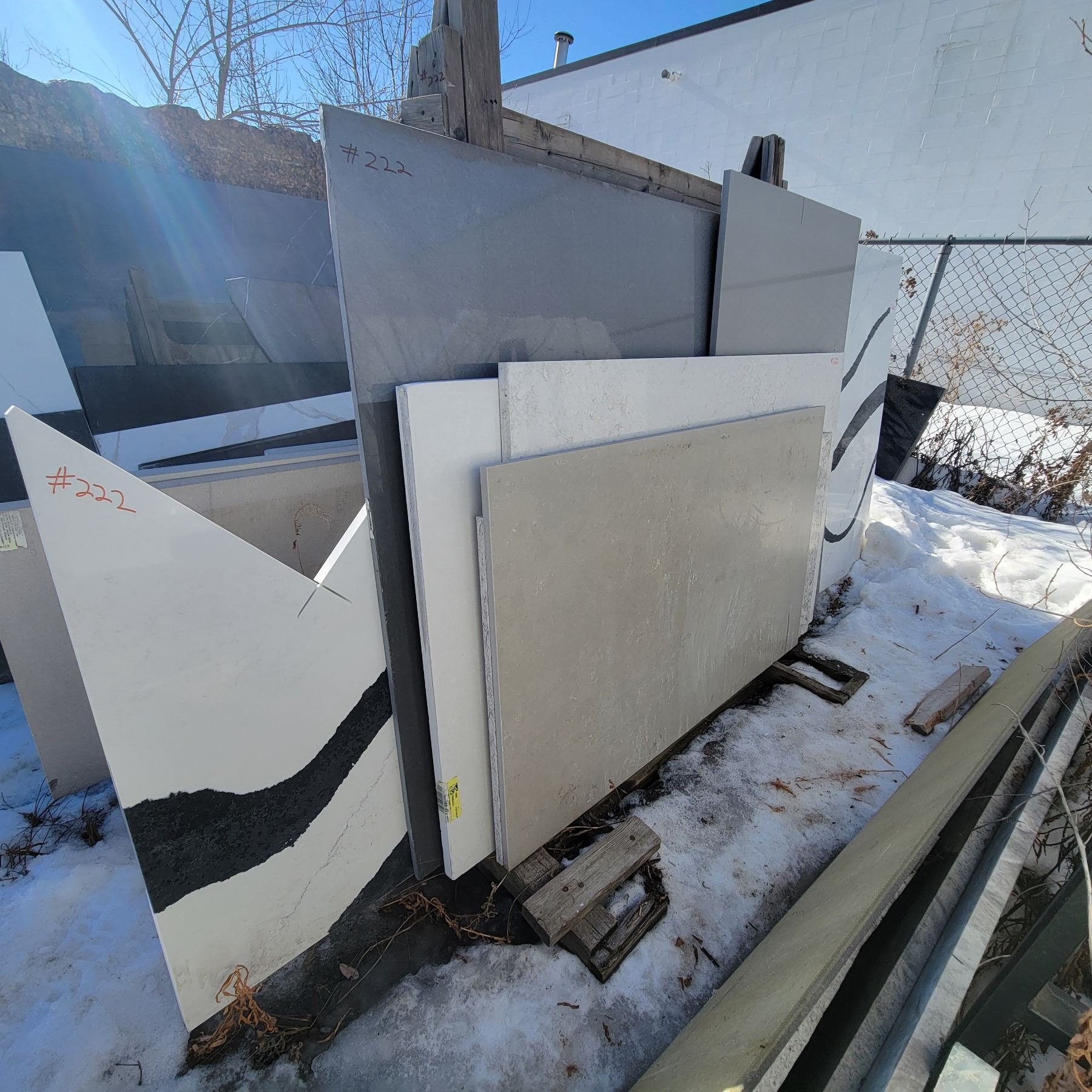 Large qty of various partial slabs of granite c/w wooden A-frame