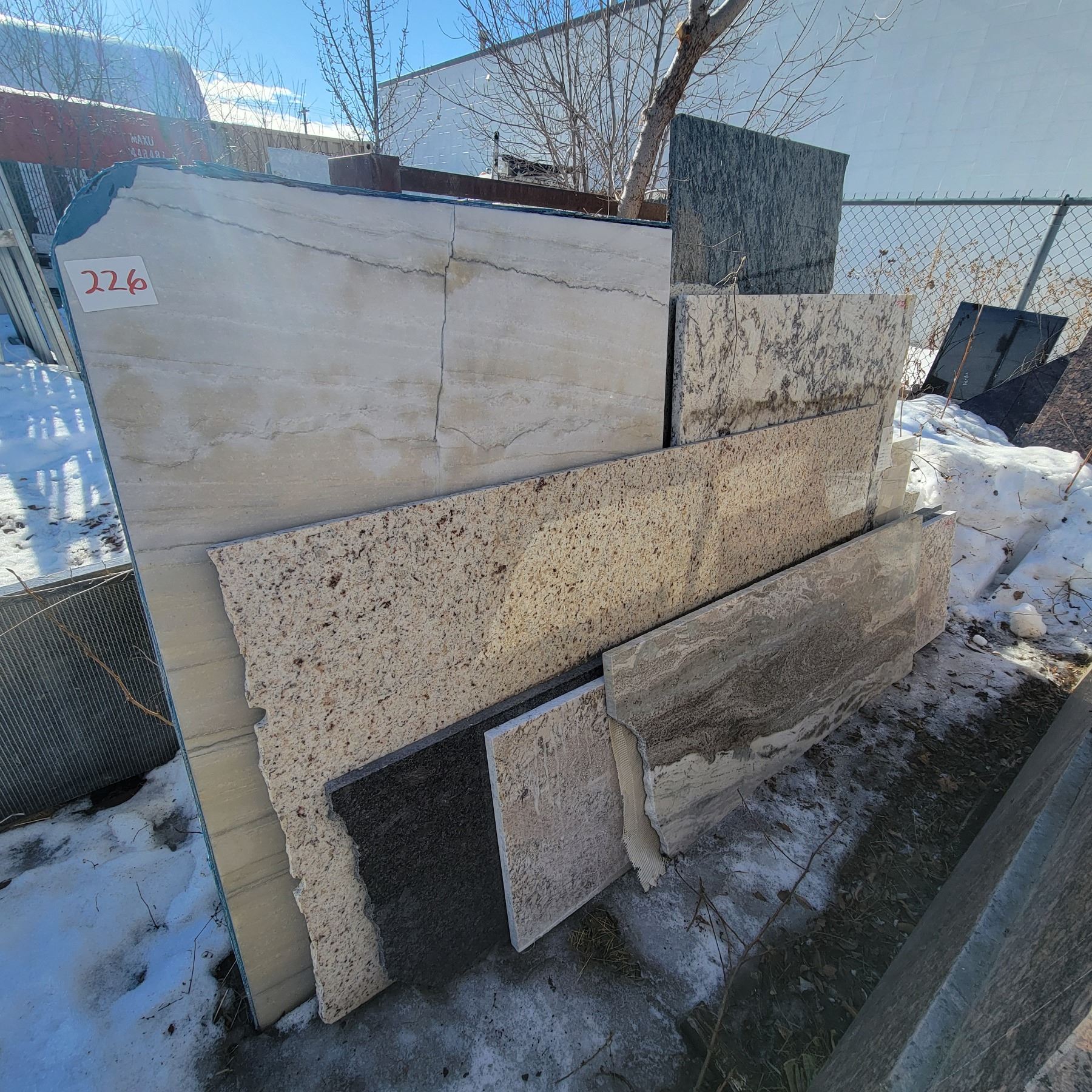 Large qty of various partial slabs of quartzite, granite c/w metal A-frame