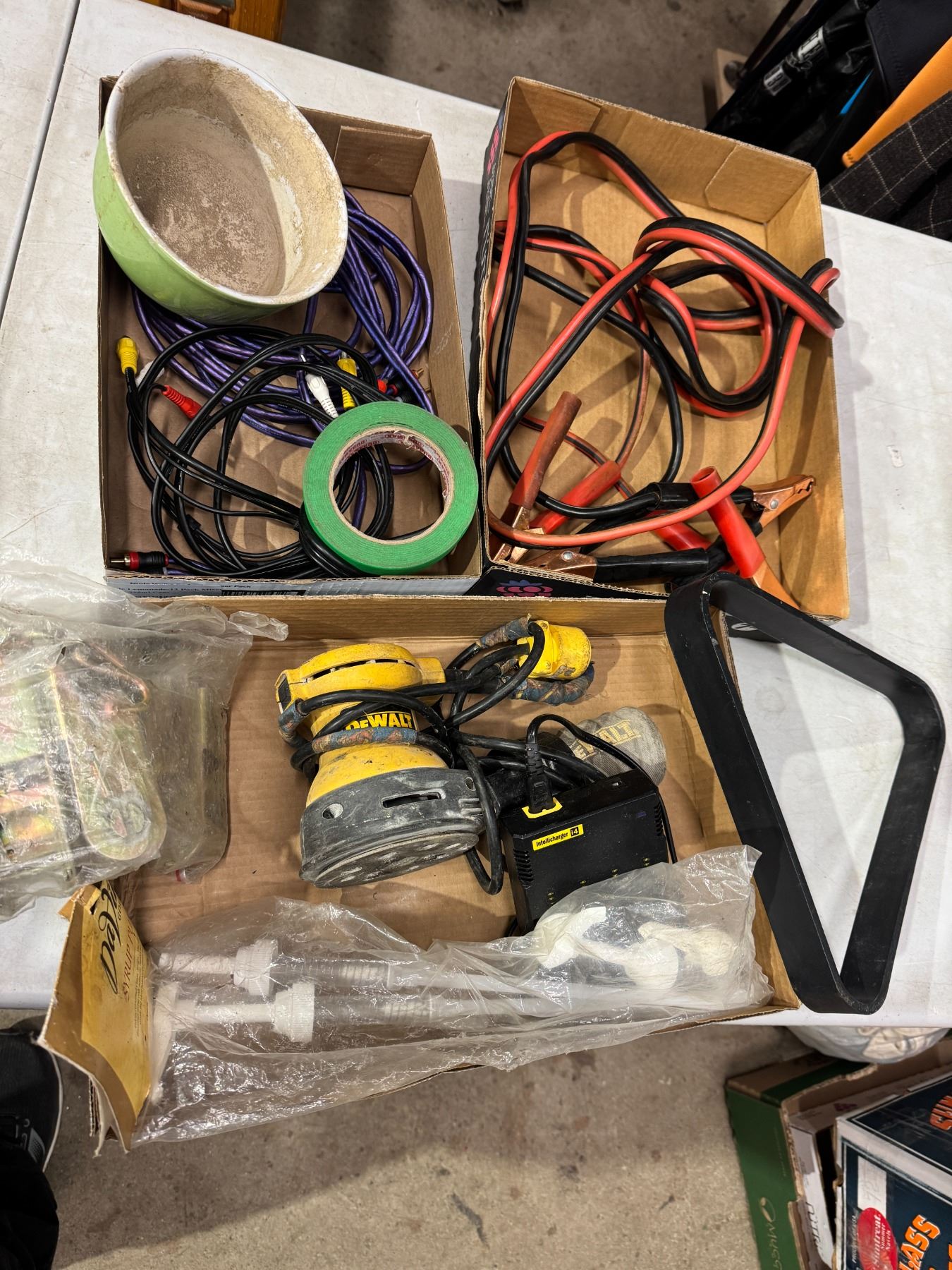 Booster cables, DeWalt tool, and other items