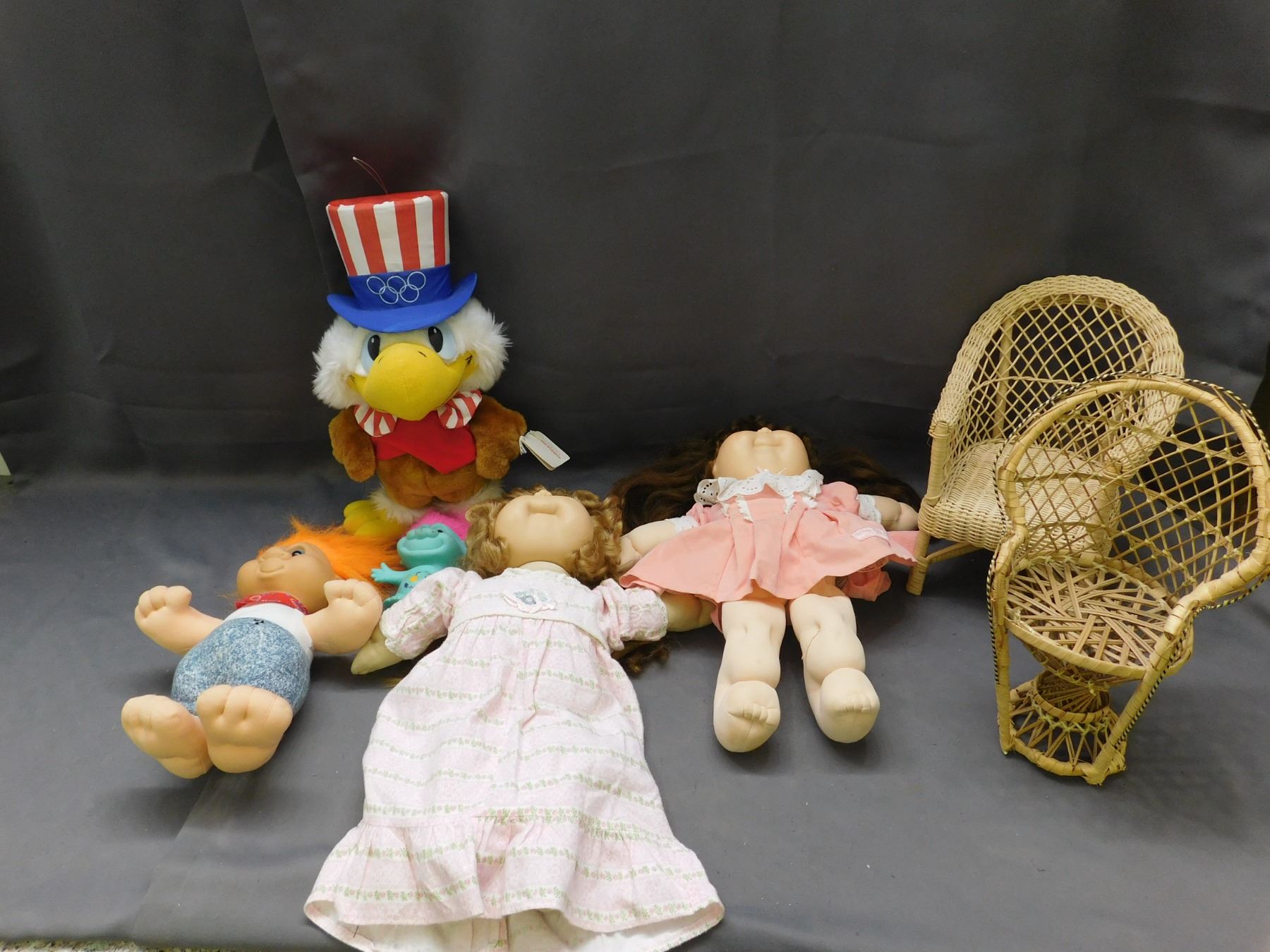 Lot of Plush Cabbage Patch Dolls, Wicker Doll Chairs, Olympic Eagle, etc