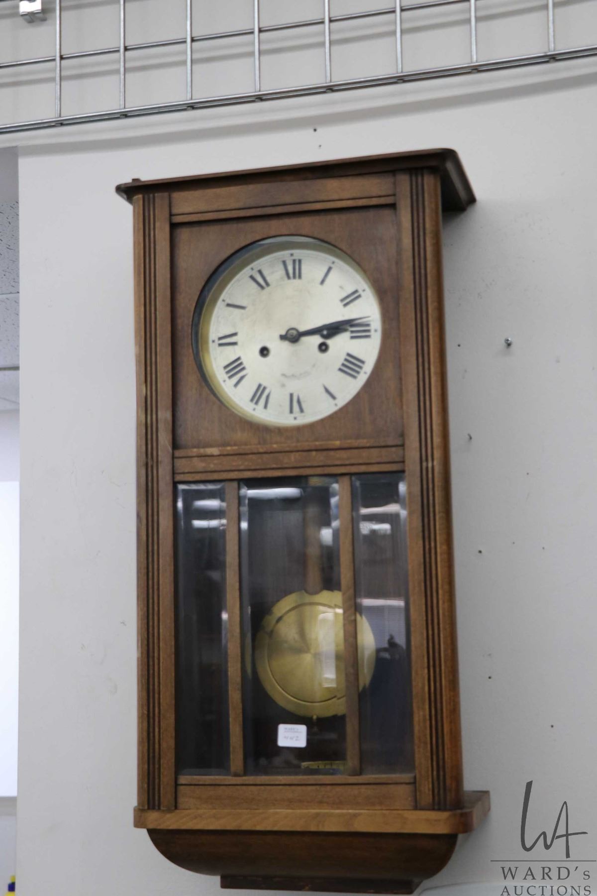 Antique English art deco style wall clock, with visible pendulum and ... Antique English art deco style wall clock, with visible pendulum and ...