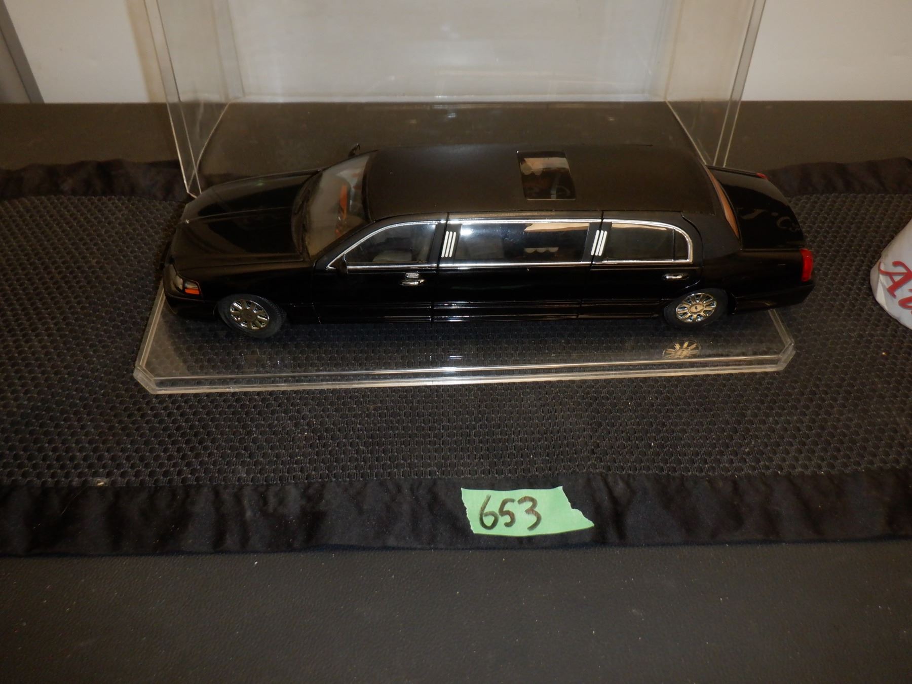 Diecast limousine with clear plastic display case by Sun Star