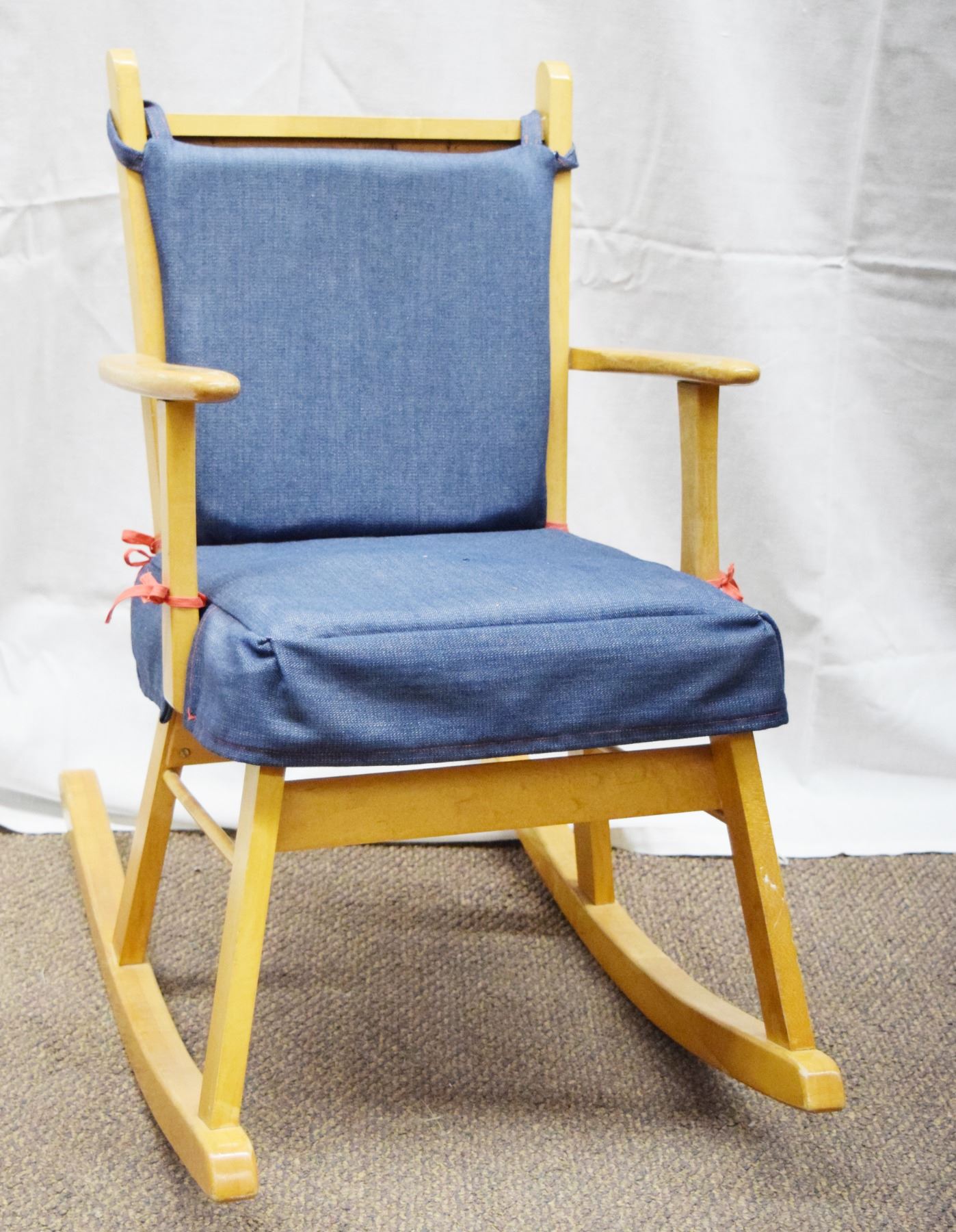 Child's wooden rocker with padded seat and back, solid back with light ...