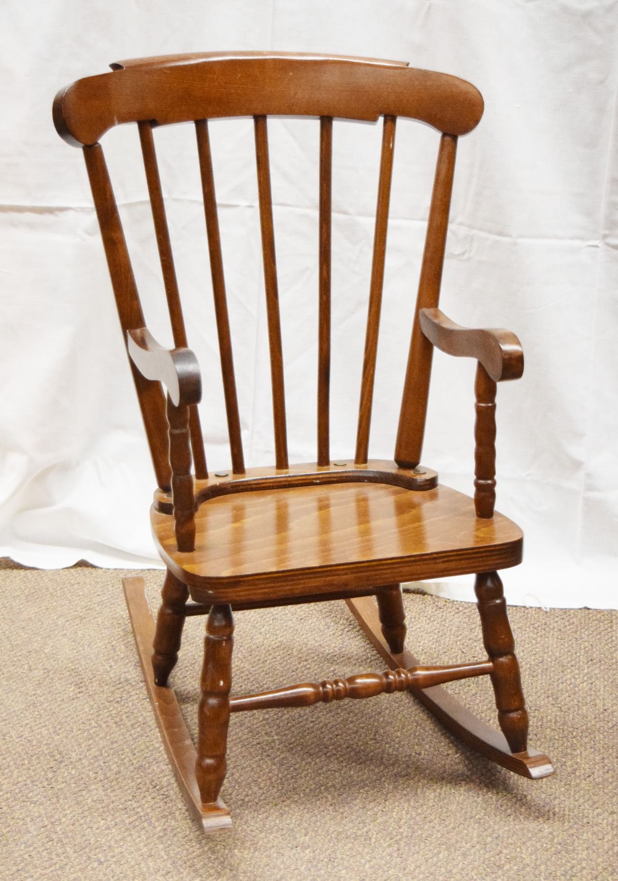 Child's wooden rocker, spindle back with dark stain, 29" tall