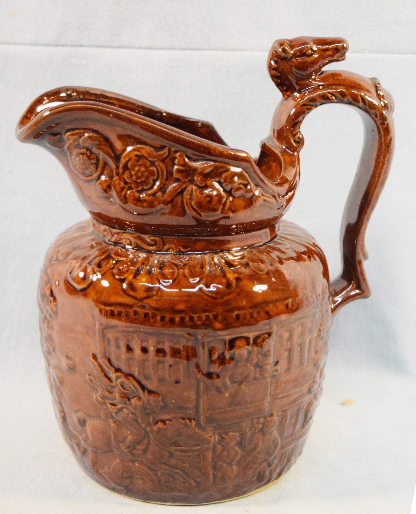Rockingham Pottery brown glazed pitcher, horse race handle, 8" tall ...