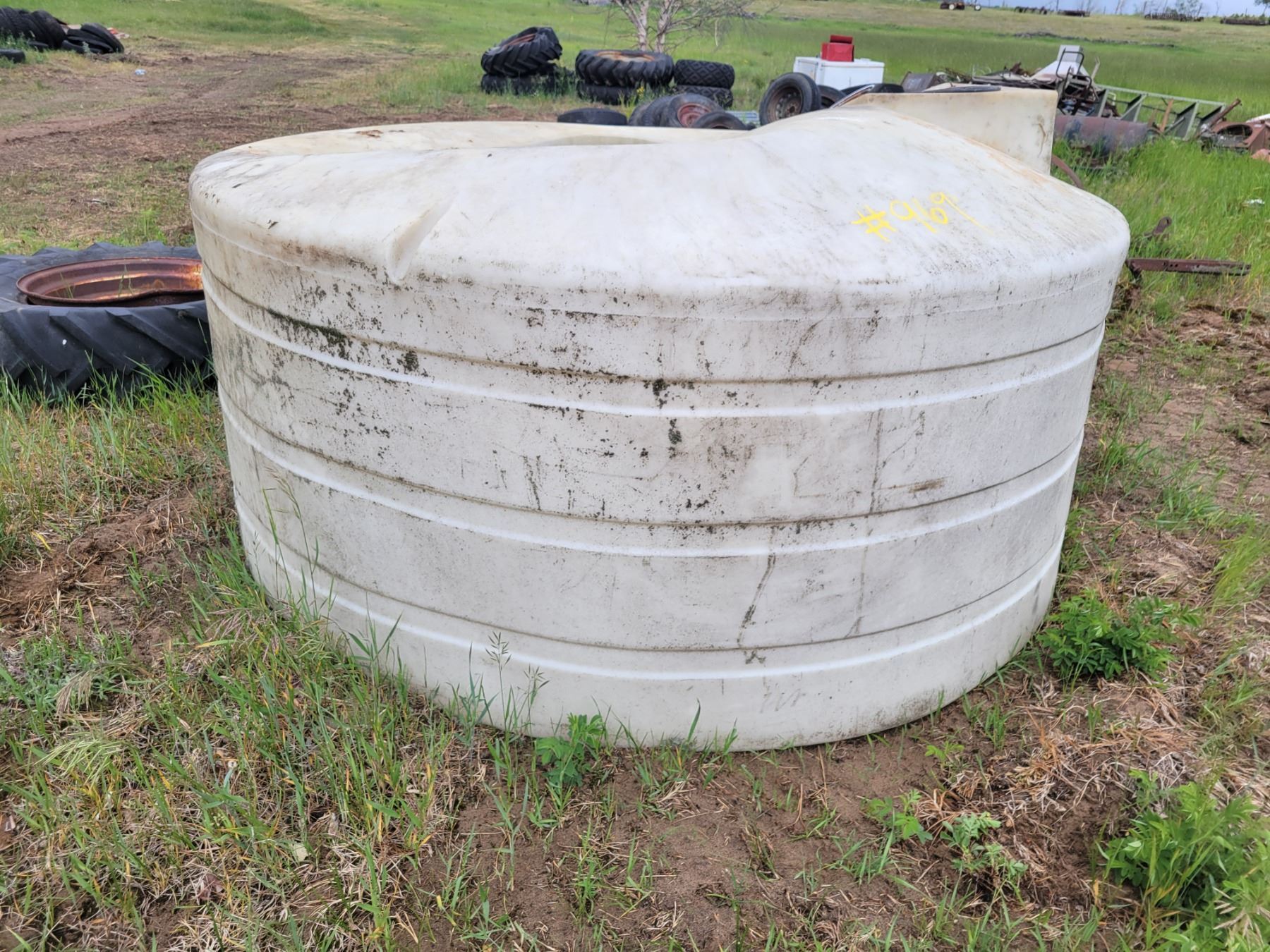 1200 gallon poly water tank. Visible hole near top.