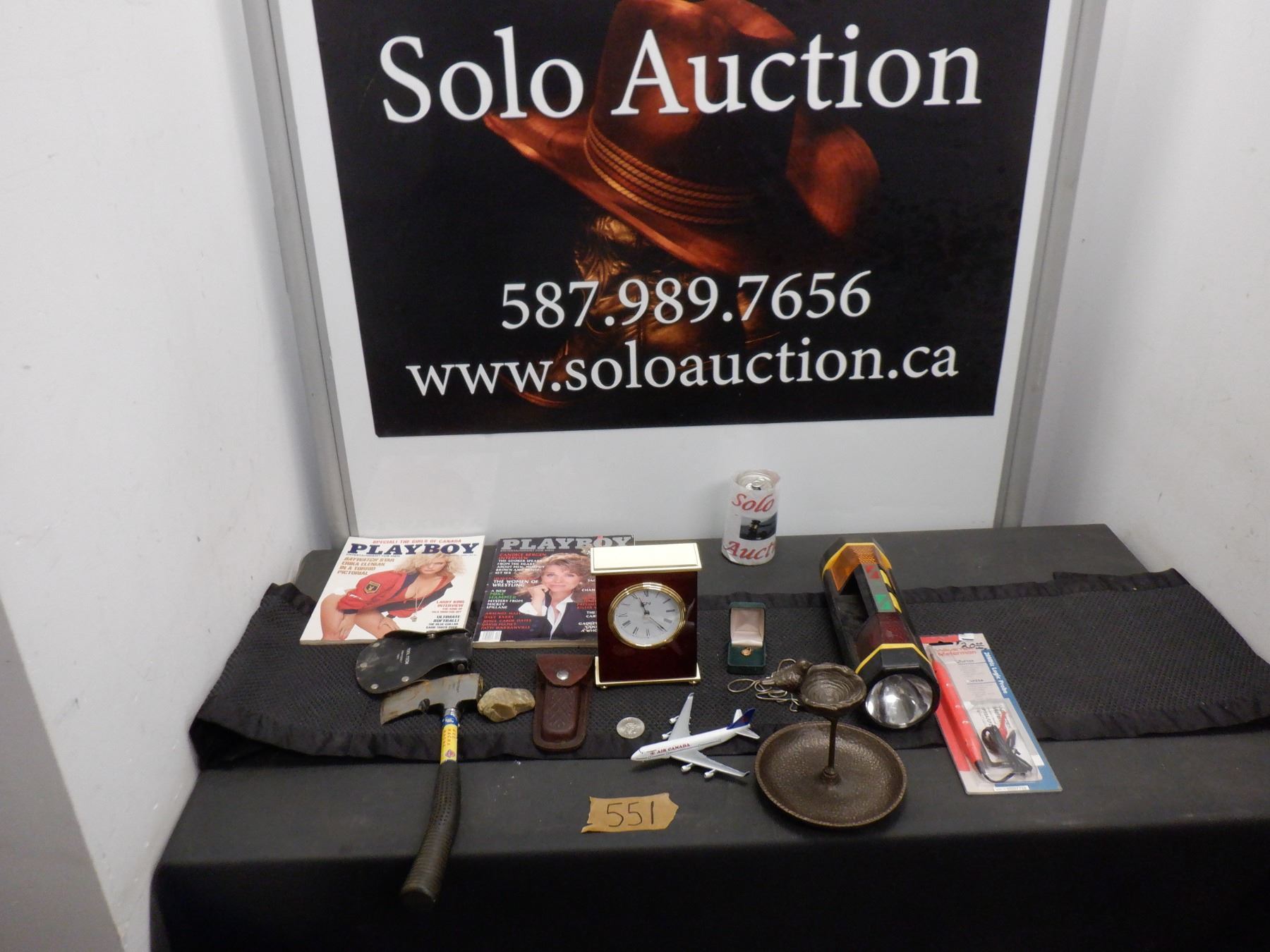 Assortment of items including vintage Playboy magazines, hatchet, bird ...