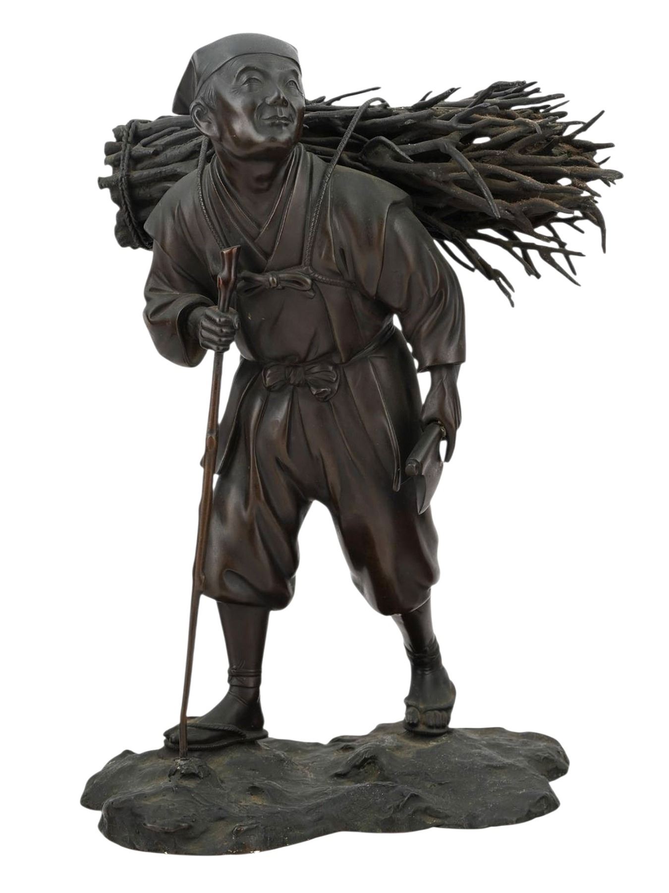A JAPANESE BRONZE OF A WALKING PEASANT WITH TIMBER, MEIJI PERIOD