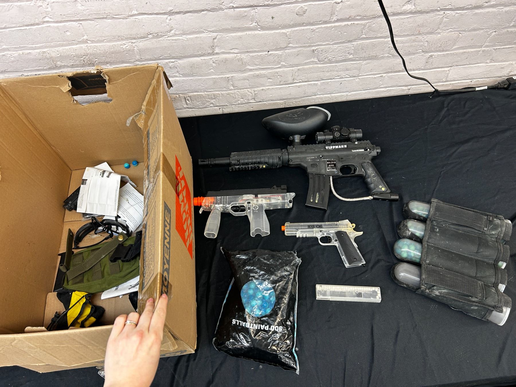 Box of Paintball Guns, Paint Balls and Accessories
