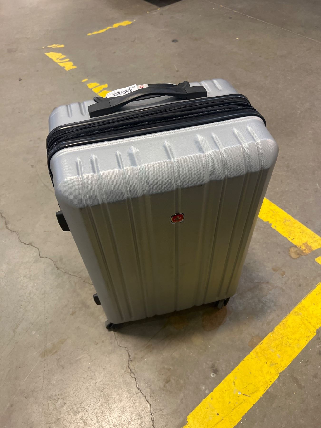 Swiss Gear Silver Hard-Shell Rolling Suitcase With Zipper Closure