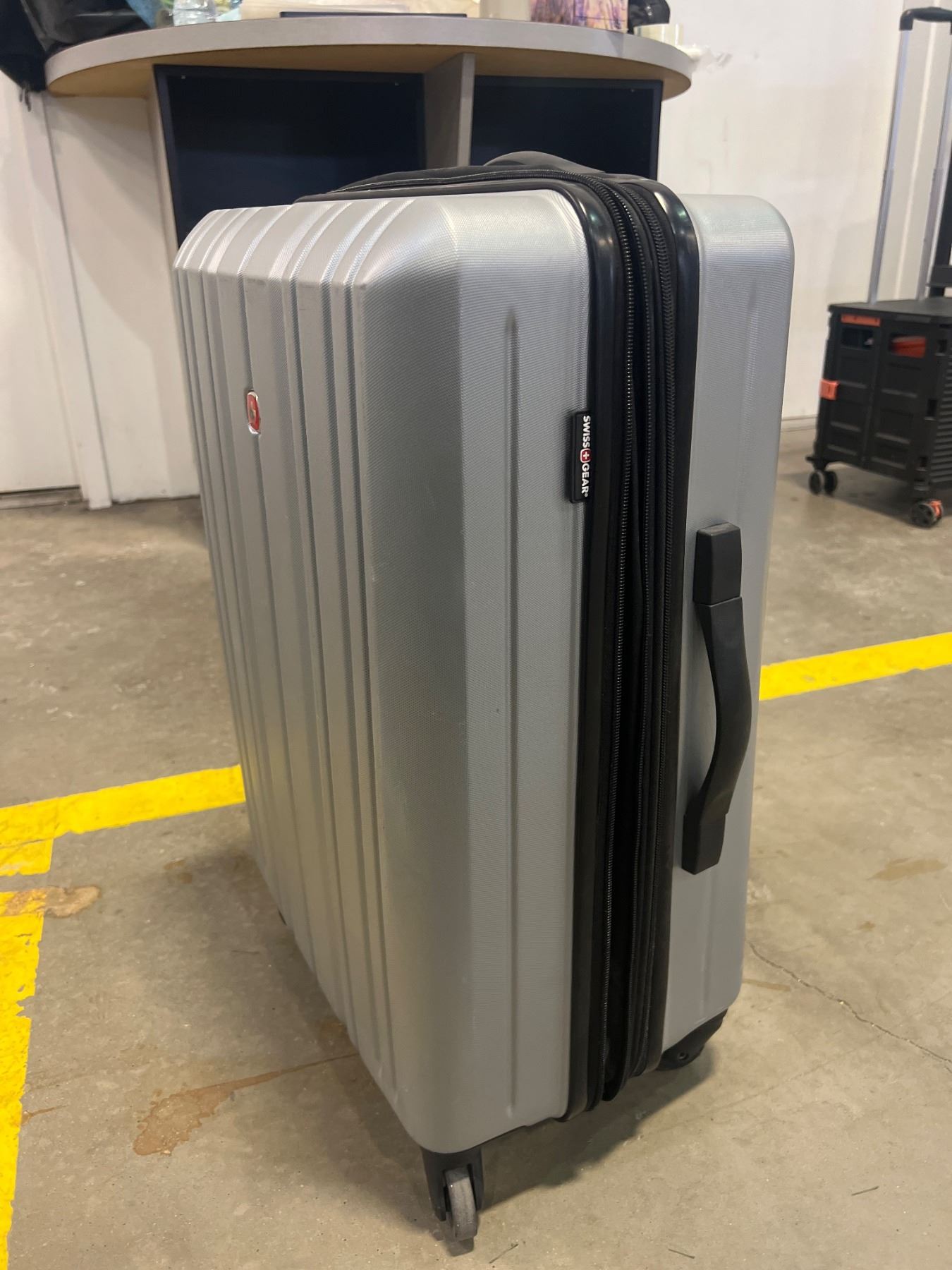 Swiss Gear Silver Hard-Shell Rolling Suitcase With Zipper Closure