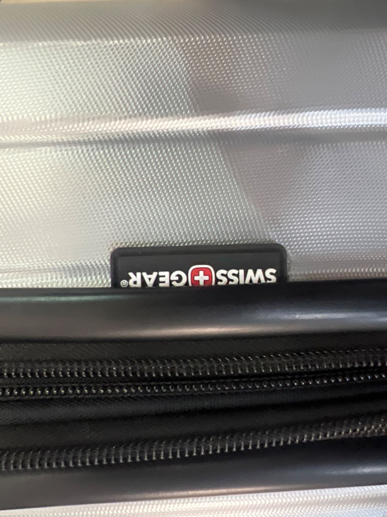 Swiss Gear Silver Hard-Shell Rolling Suitcase With Zipper Closure