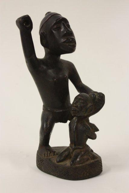 African statue "Man Chopping off Head"