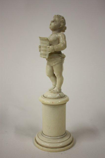 European ivory figure of "Cupid Holding Book"