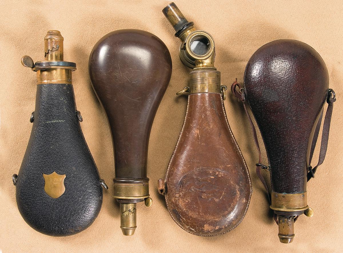 Four Leather Covered or Hard Rubber Powder and Shot Flasks