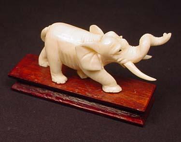 VINTAGE IVORY CARVED ELEPHANT FIGURINE W/ WOOD BAS