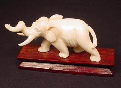 VINTAGE IVORY CARVED ELEPHANT FIGURINE W/ WOOD BAS