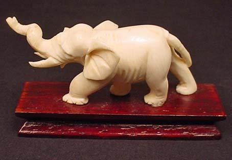 VINTAGE IVORY CARVED ELEPHANT FIGURINE W/ WOOD BAS