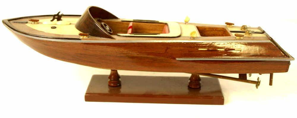 Hand crafted mahogany speed boat model measuring 16" long.