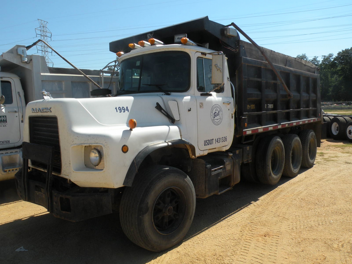 1997 MACK DM690S TRI-AXLE DUMP - J.M. Wood Auction Company, Inc.