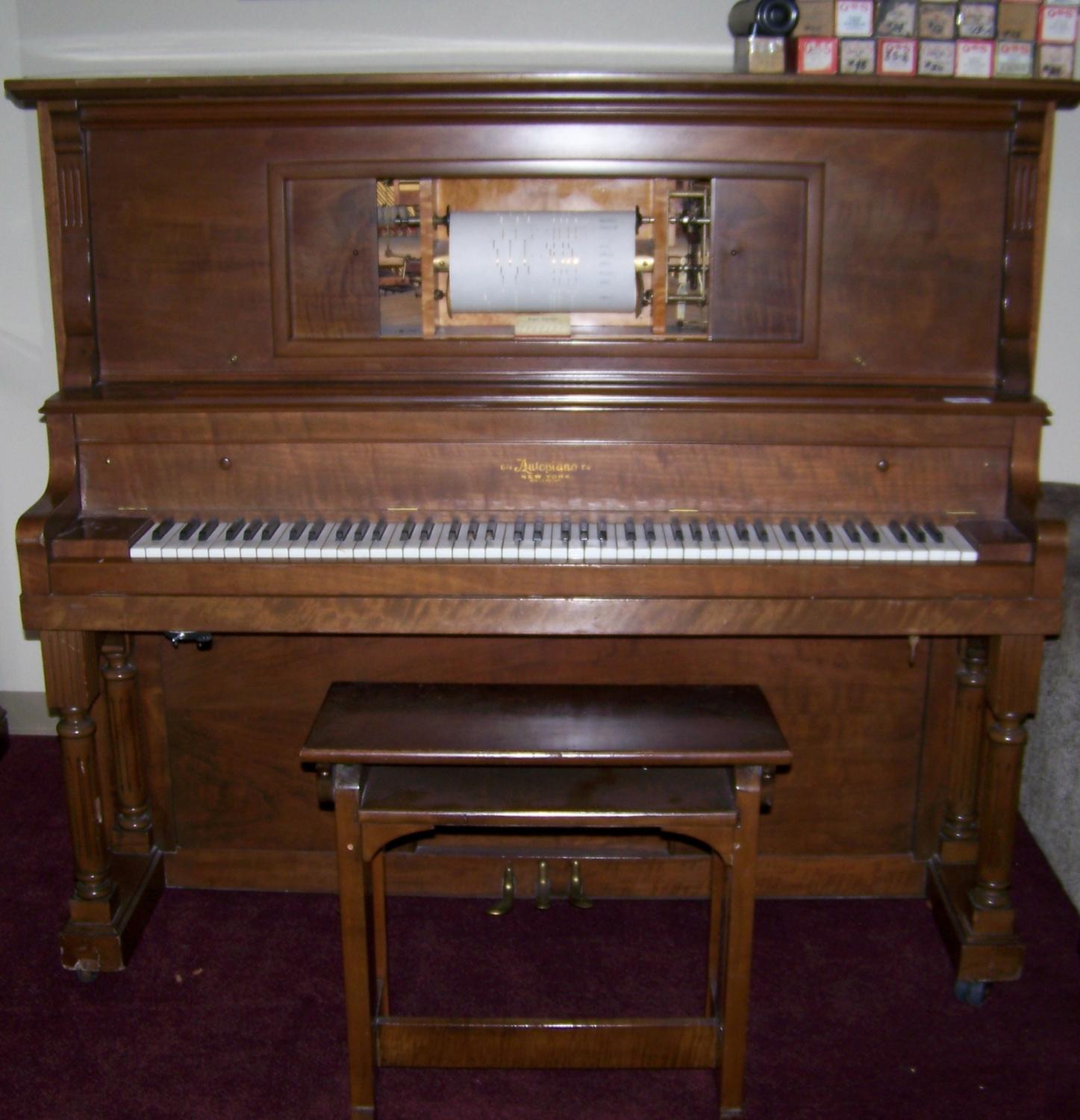 Antique Piano with box of Rolls & original bench.1914
